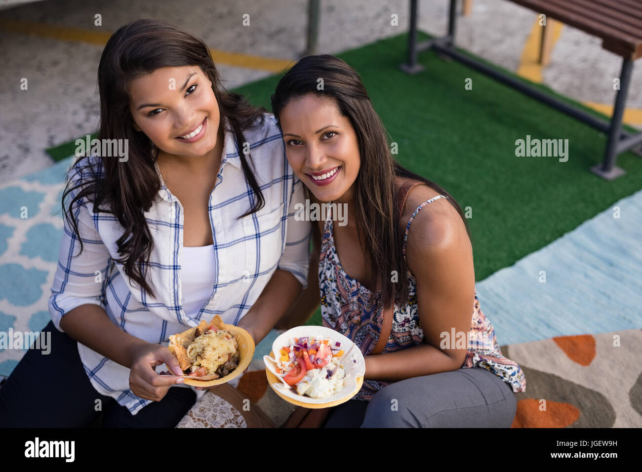 Portrait of happy friends having snacks Stock Photo - Alamy
