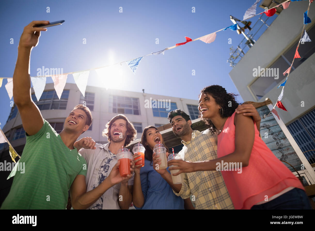 Happy friends taking selfie from mobile phone Stock Photo - Alamy