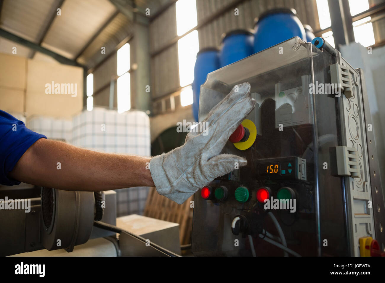 Hand pressing a control button in factory Stock Photo - Alamy