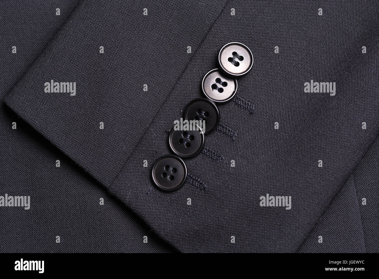 Four buttons on a black business jacket sleeve close up Stock Photo - Alamy
