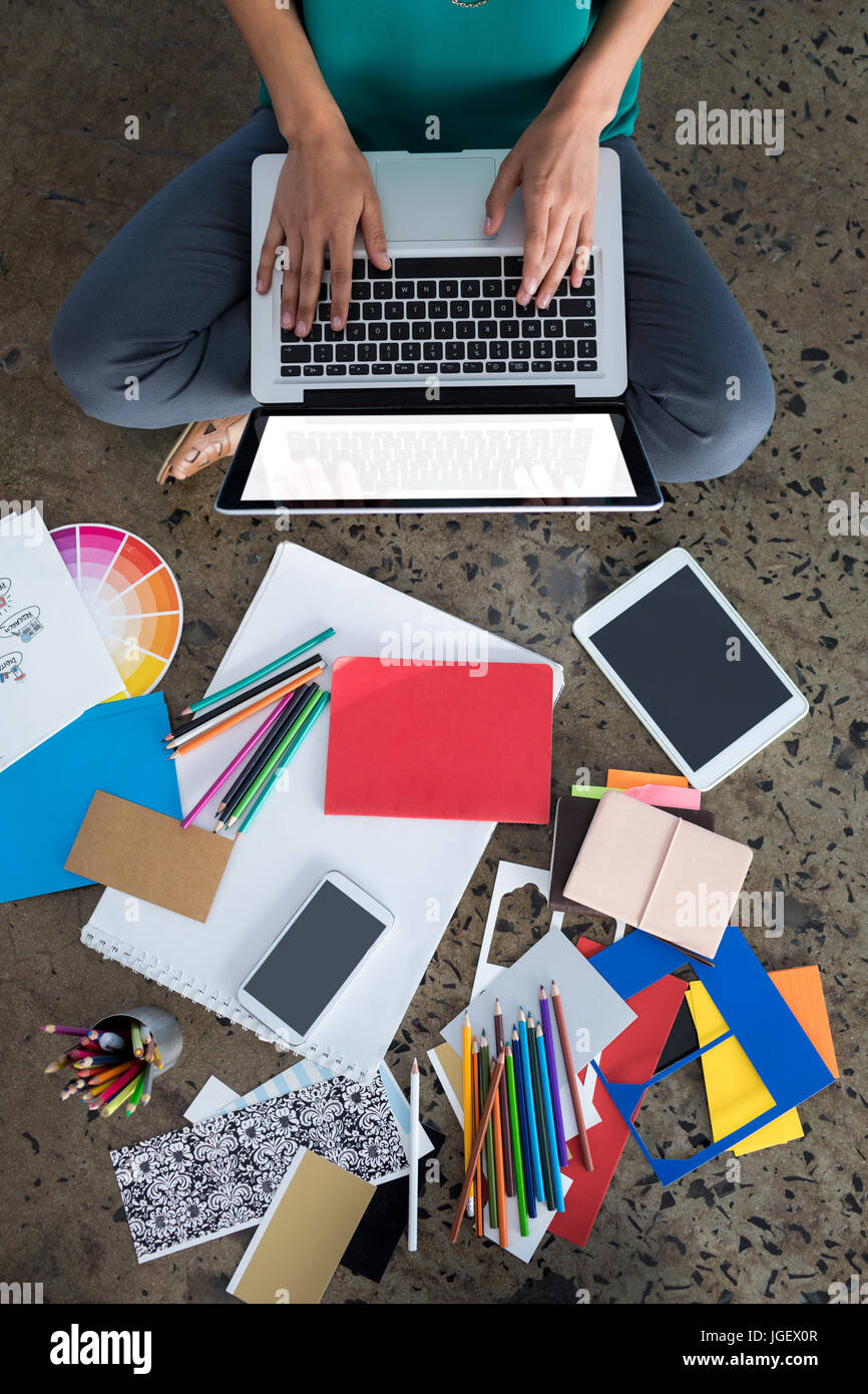 Female executive using laptop in office Stock Photo - Alamy