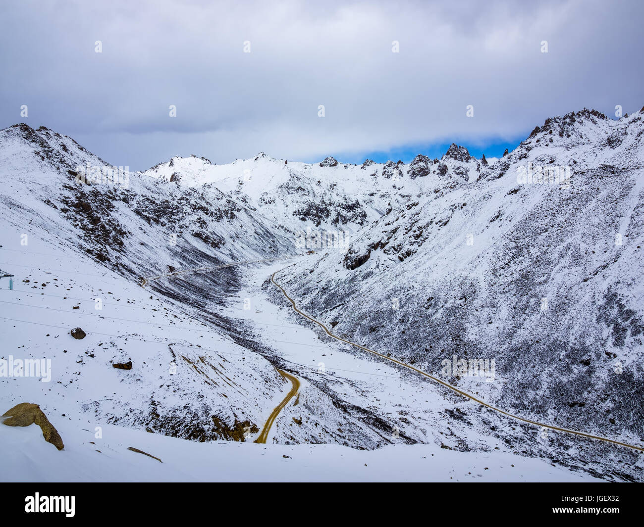 Aerial view of highway at the valley of snow mountain in Sichuan China ...