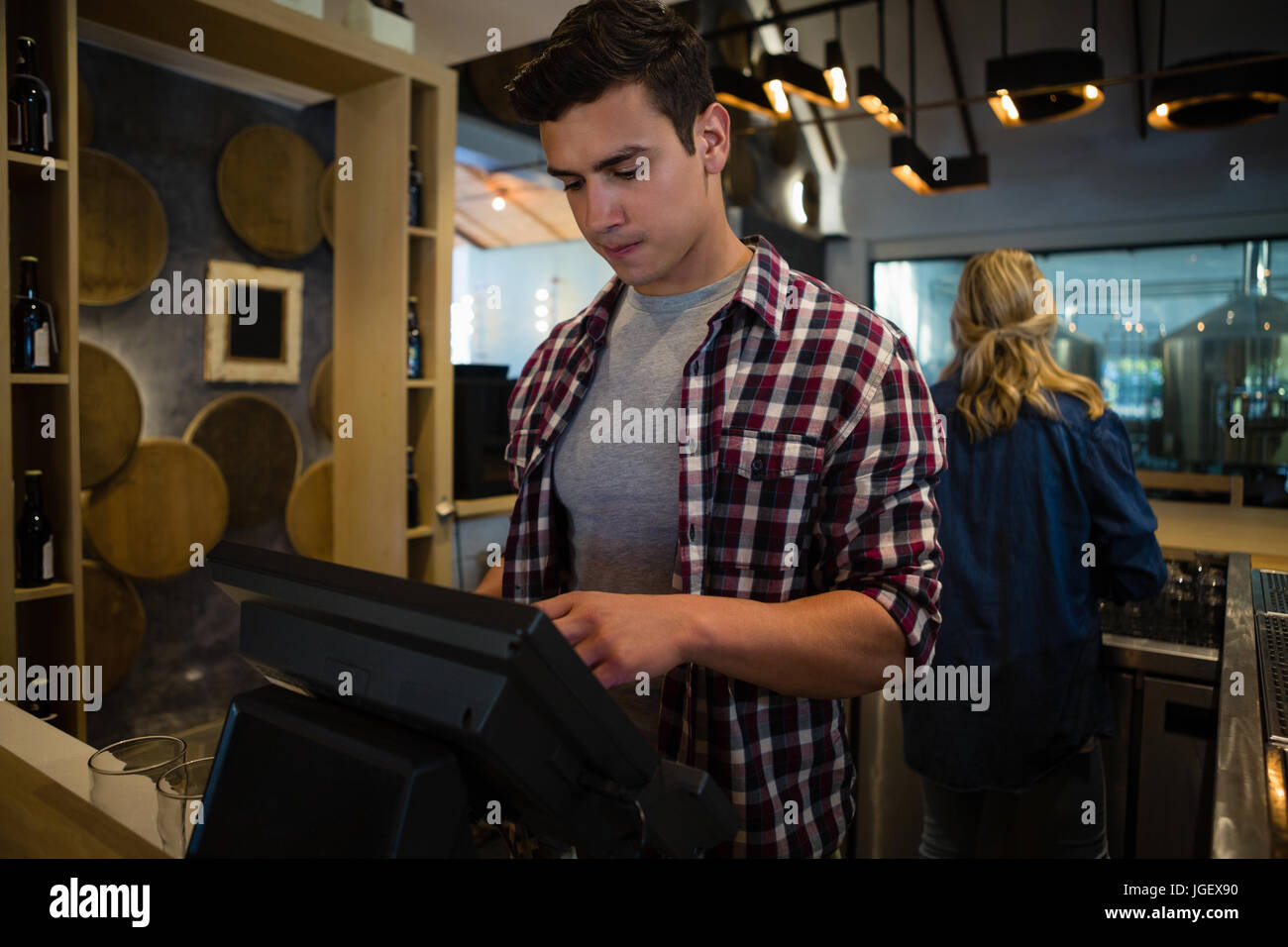 Male owner using cash register at restaurant Stock Photo - Alamy