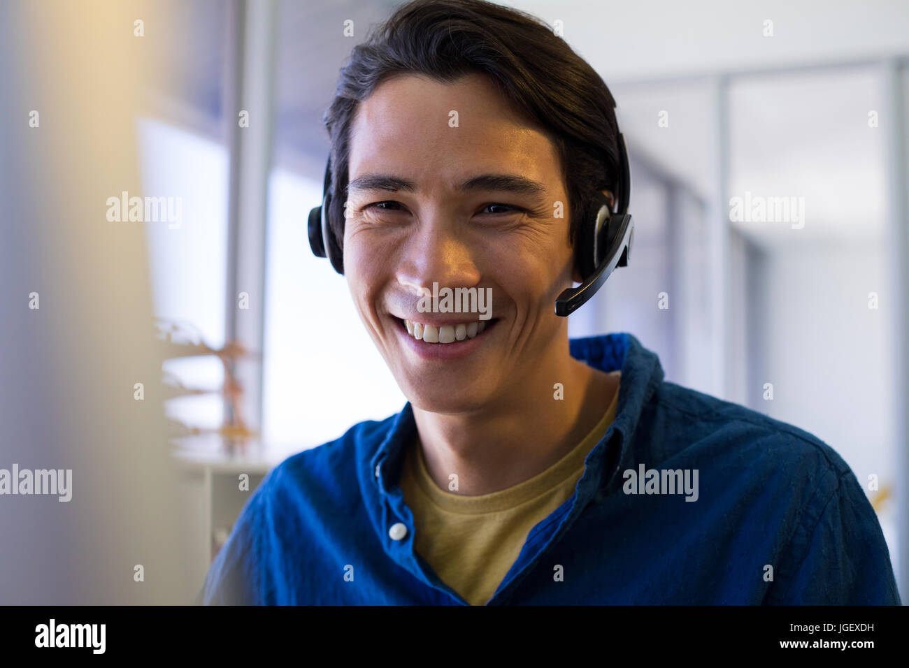 Portrait of male executive in headset at his desk in office Stock Photo ...