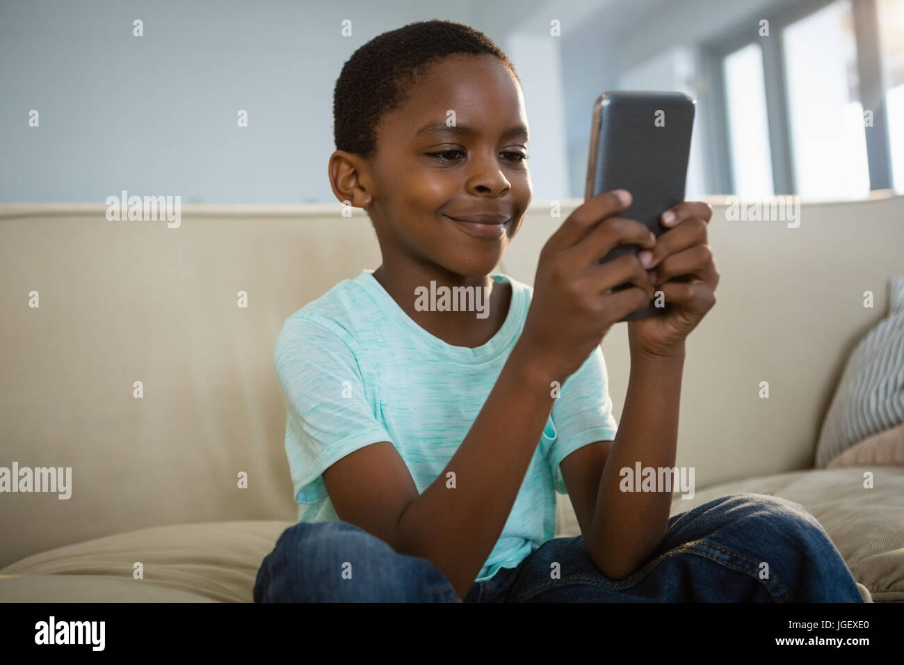 Boy child mobile phone couch hi-res stock photography and images - Alamy
