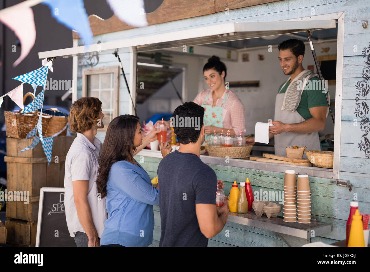 Smiling waiter taking order from customer at counter Stock Photo - Alamy Smiling waiter taking order from customer at counter Stock Photo - Alamy
