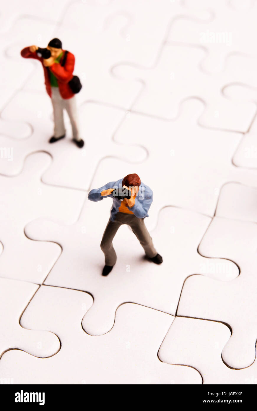 miniature figurines of photographers on jigsaw puzzle Stock Photo - Alamy