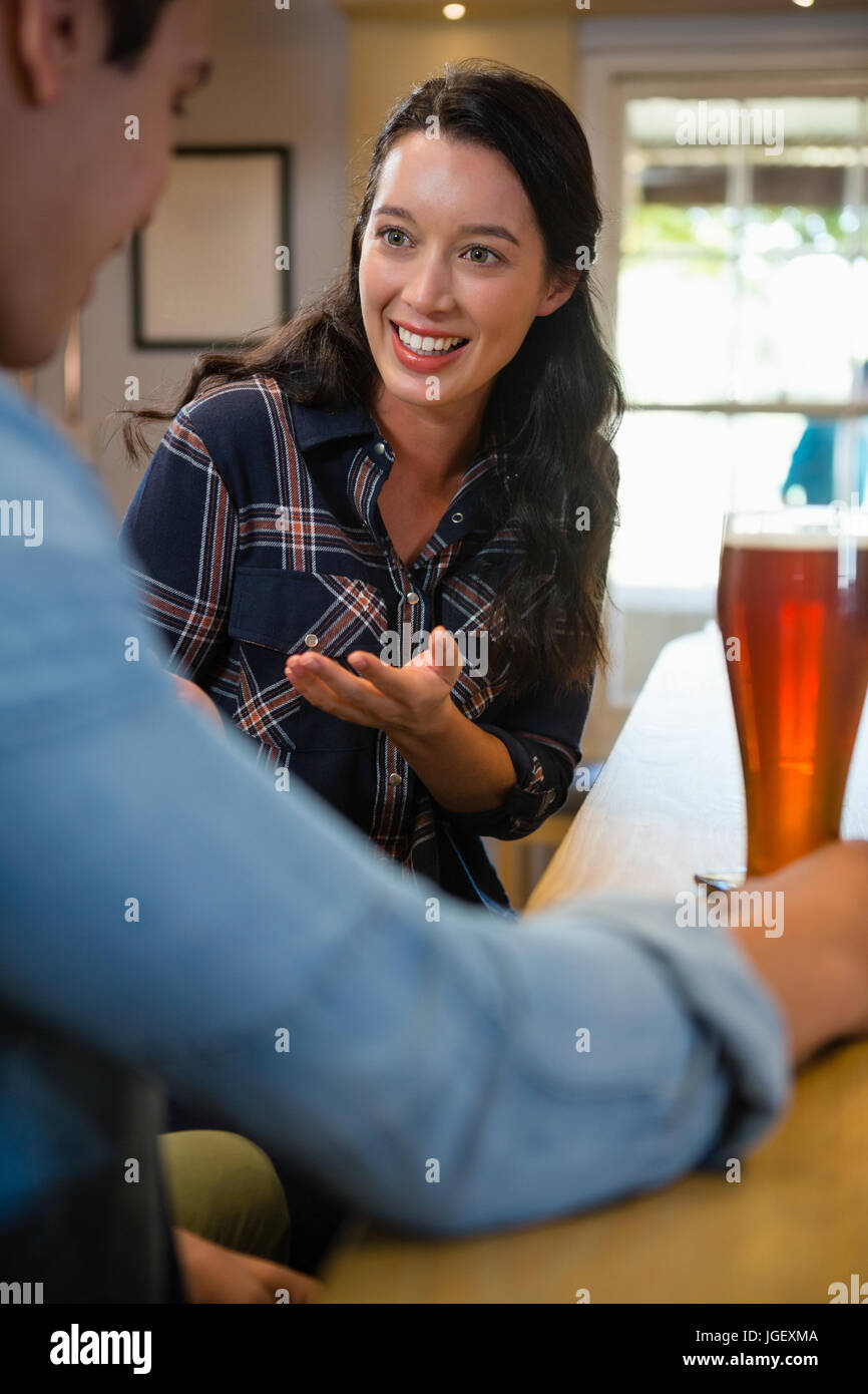 Woman talking friend holding beer hi-res stock photography and images ...