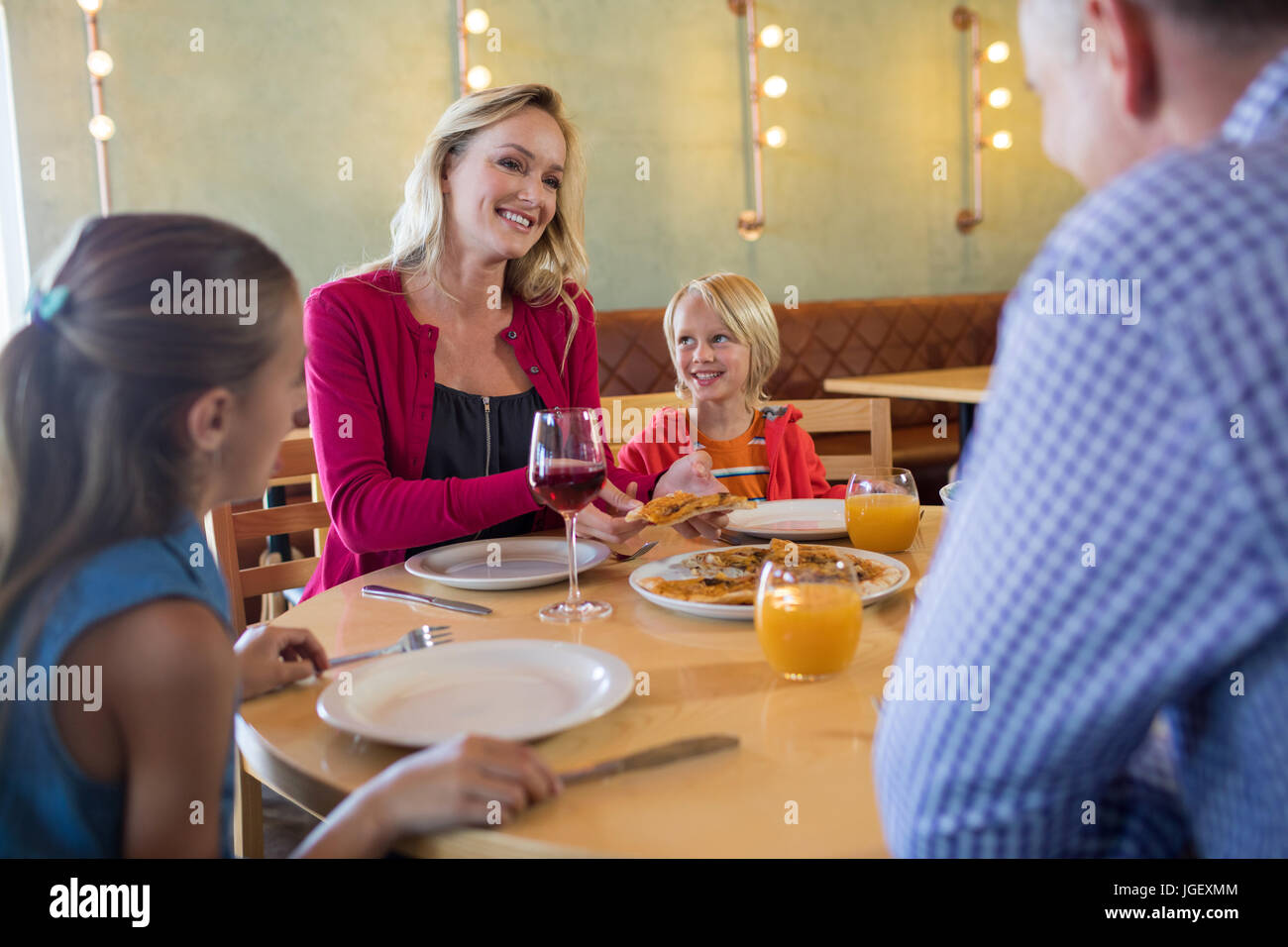 Happy family talking while enjoying appetizer in restaurant Stock Photo ...