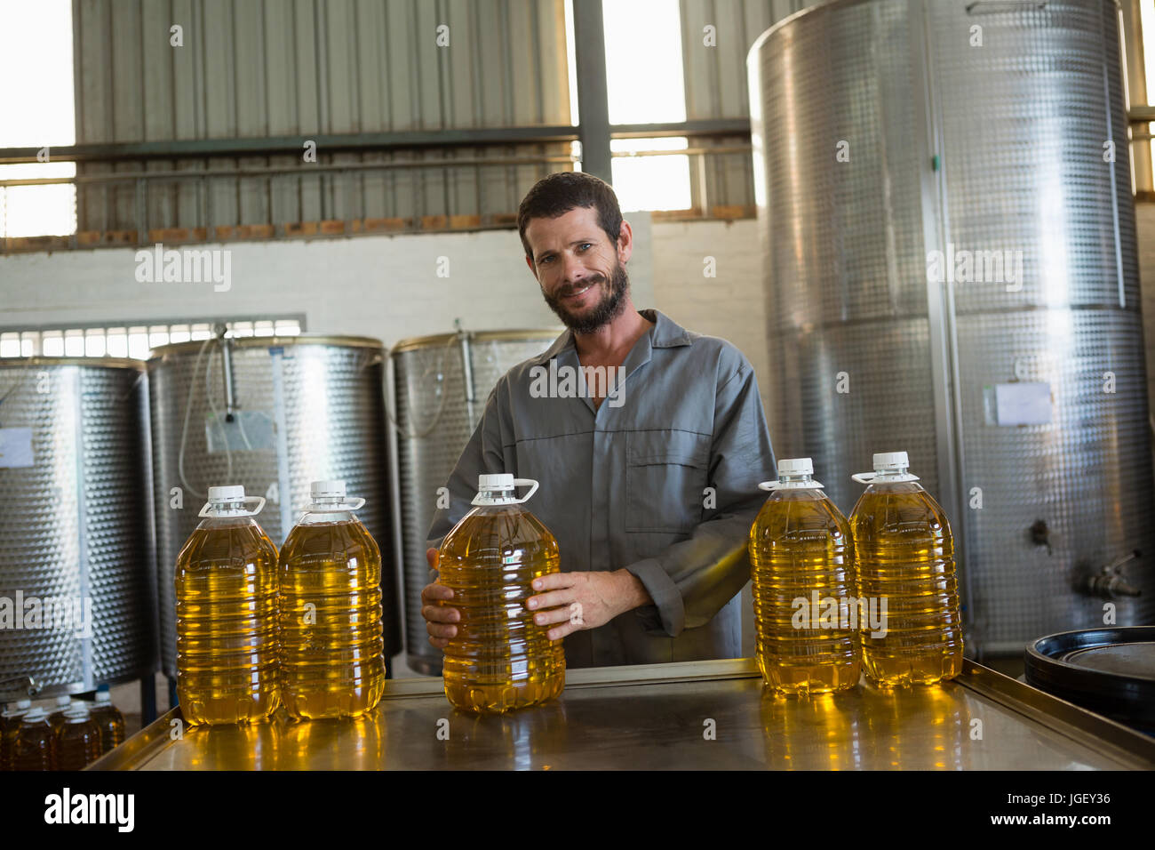 Factory worker holding oil bottle hi-res stock photography and images ...