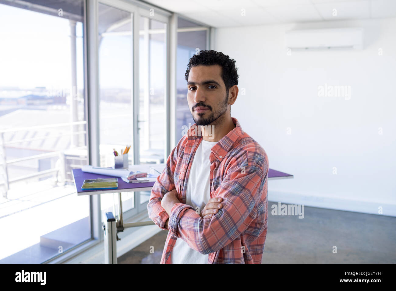 Portrait of male architect standing with arms crossed in office Stock ...