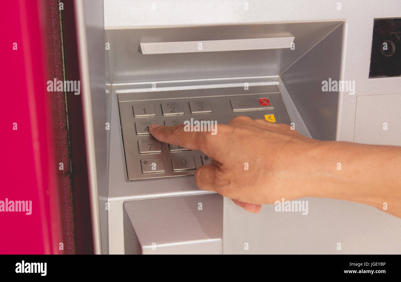 Hand of a woman push botton in ATM, using an ATM. Woman using an ATM ...