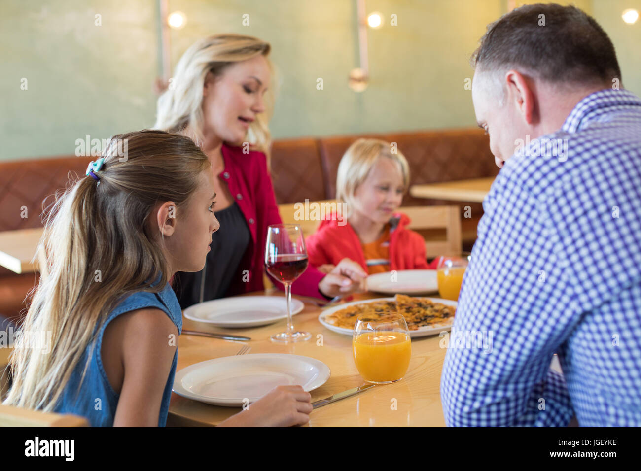 Daughter talking to parents table hi-res stock photography and images ...