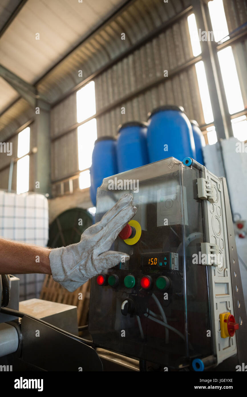 Hand pressing a control button in factory Stock Photo - Alamy