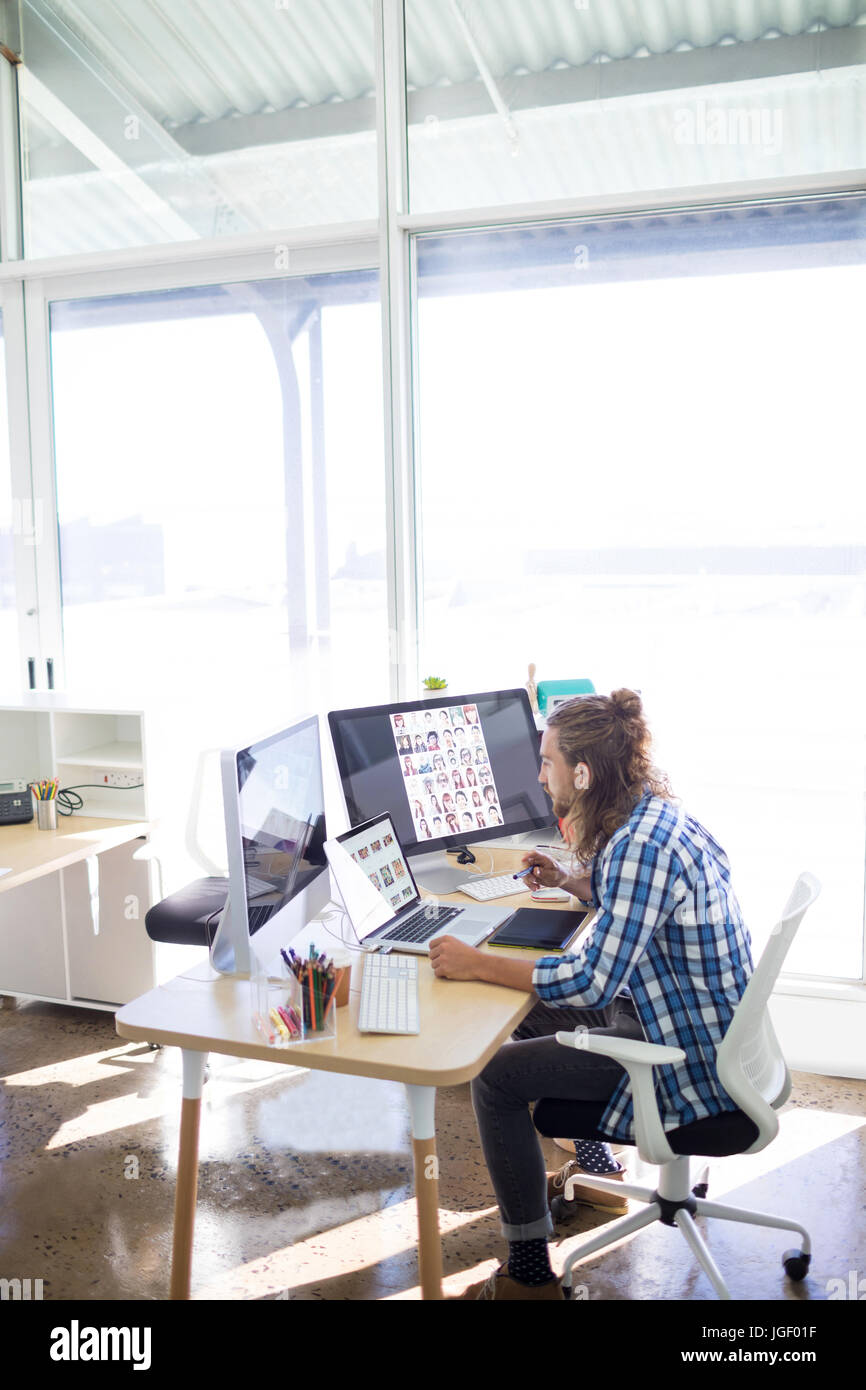 Male executive working at his desk in office Stock Photo - Alamy