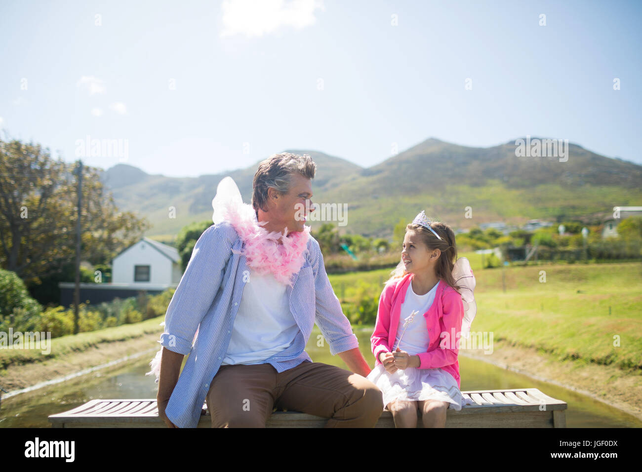 Daughter and father in fairy costume interacting with each other at ...