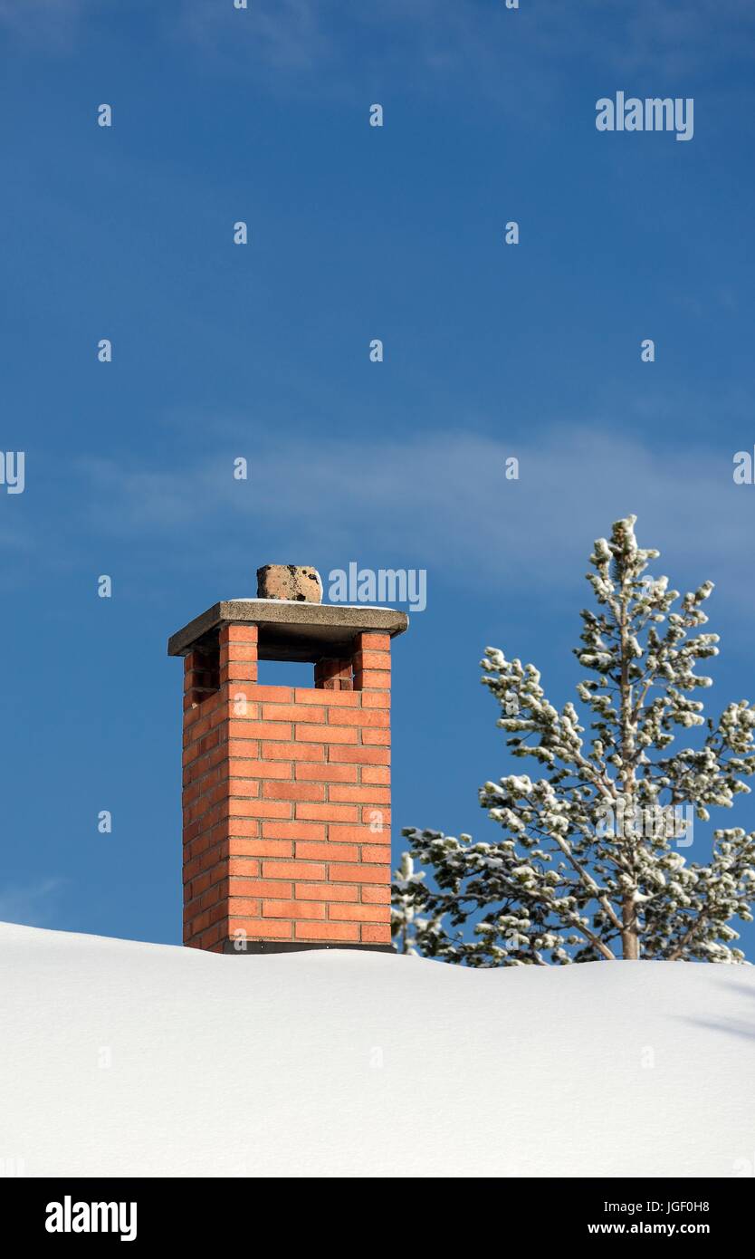 Chimney on snowy roof Stock Photo - Alamy