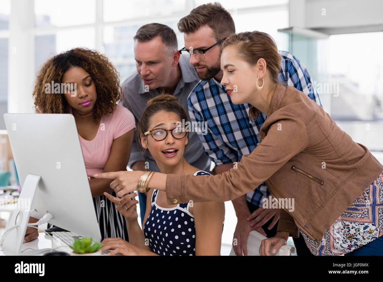 Business executives discussing over desktop hi-res stock photography ...