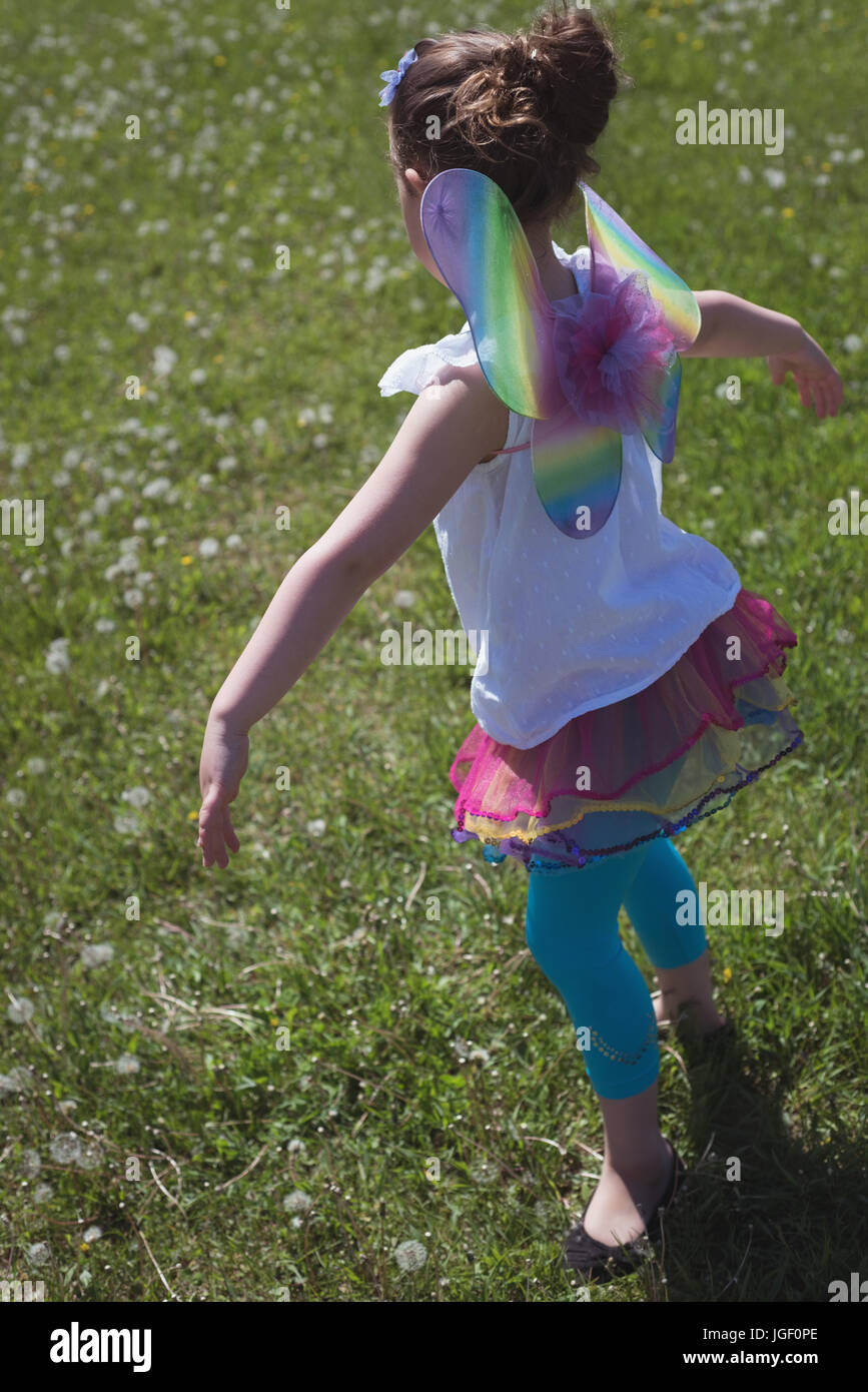 Girl playing on grass in park Stock Photo - Alamy