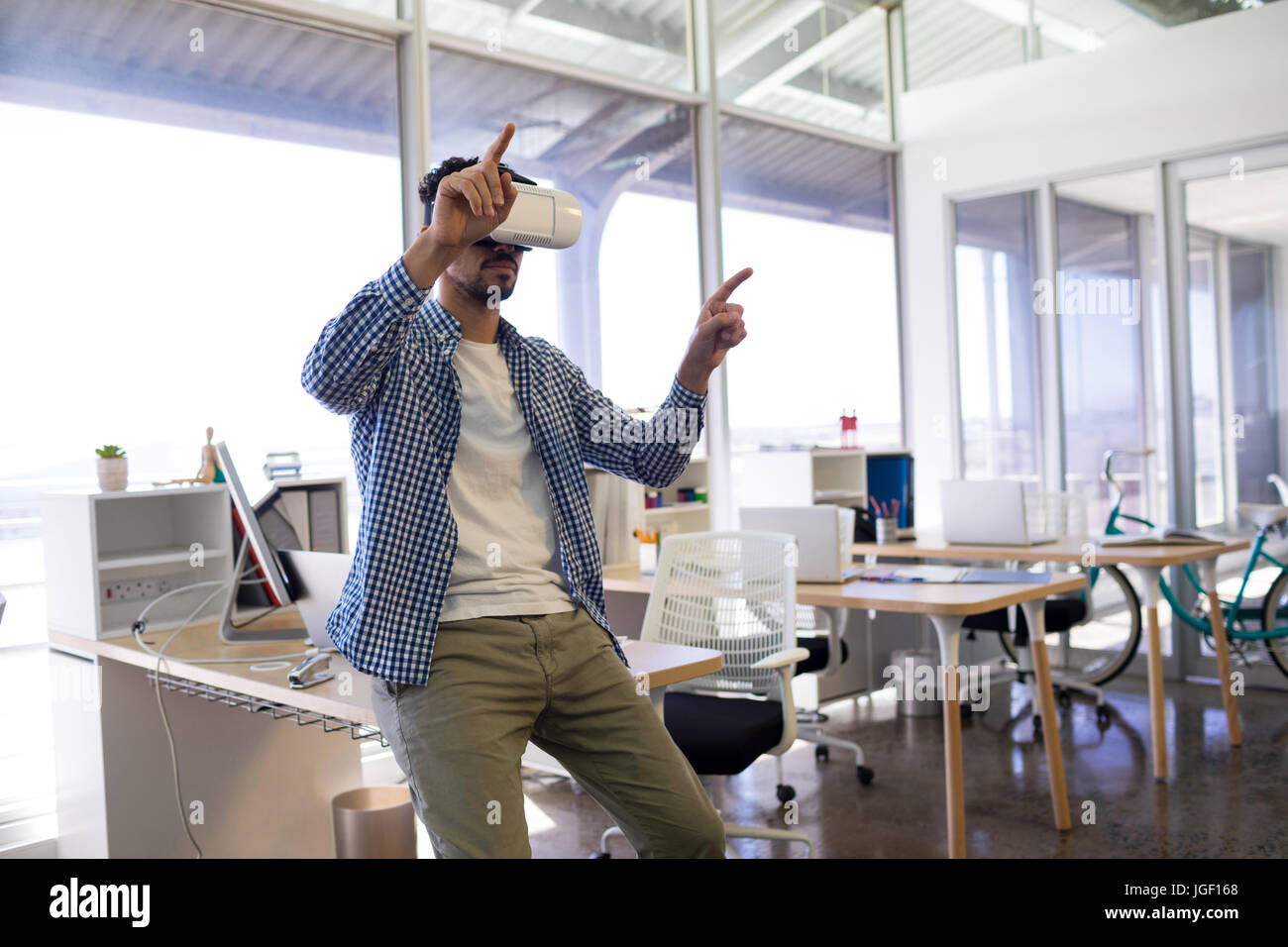 Male executive using virtual reality headset in office Stock Photo - Alamy