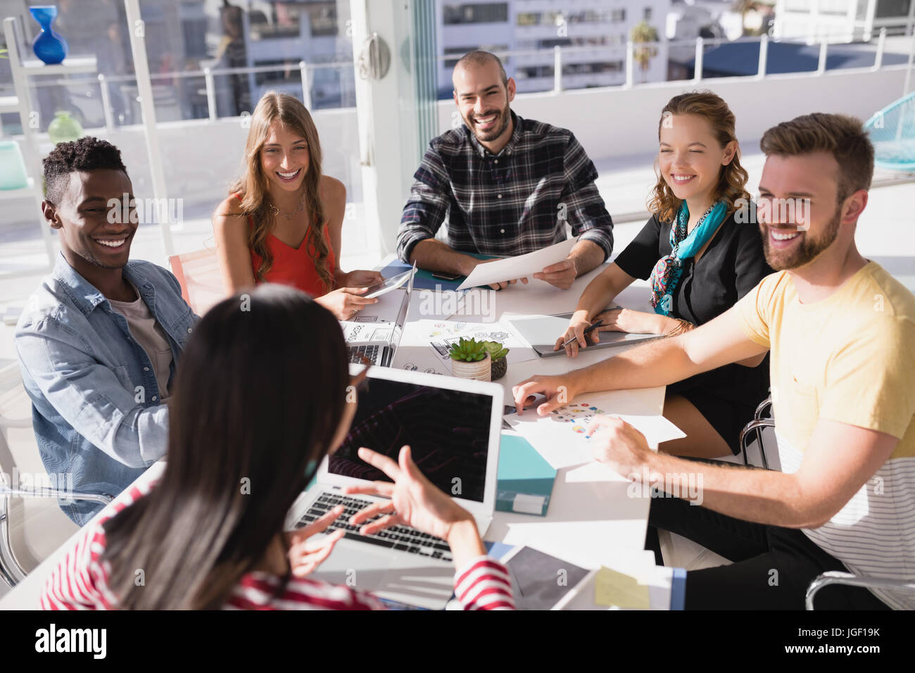 Business executives discussing during meeting in office Stock Photo - Alamy