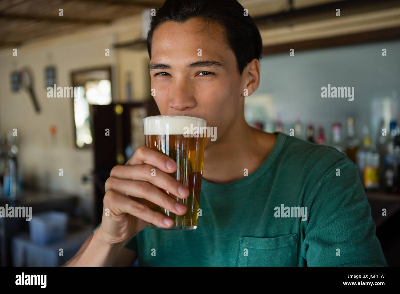 Young man drinking hotel bar hi-res stock photography and images - Alamy
