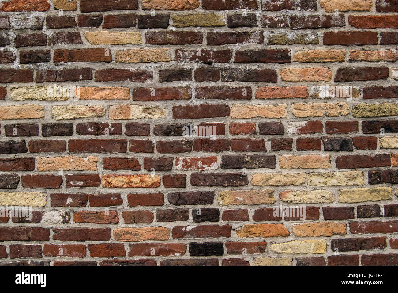 An old weathered brick wall background with multi-colored bricks Stock ...