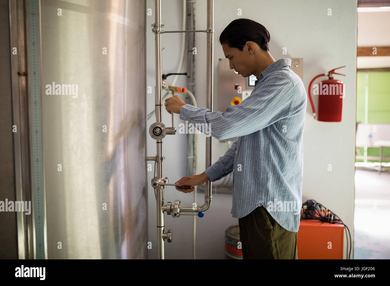 Manager operating machinery in warehouse of restaurant Stock Photo - Alamy
