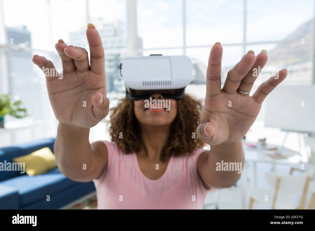 Female executive using virtual reality headset in the office Stock ...