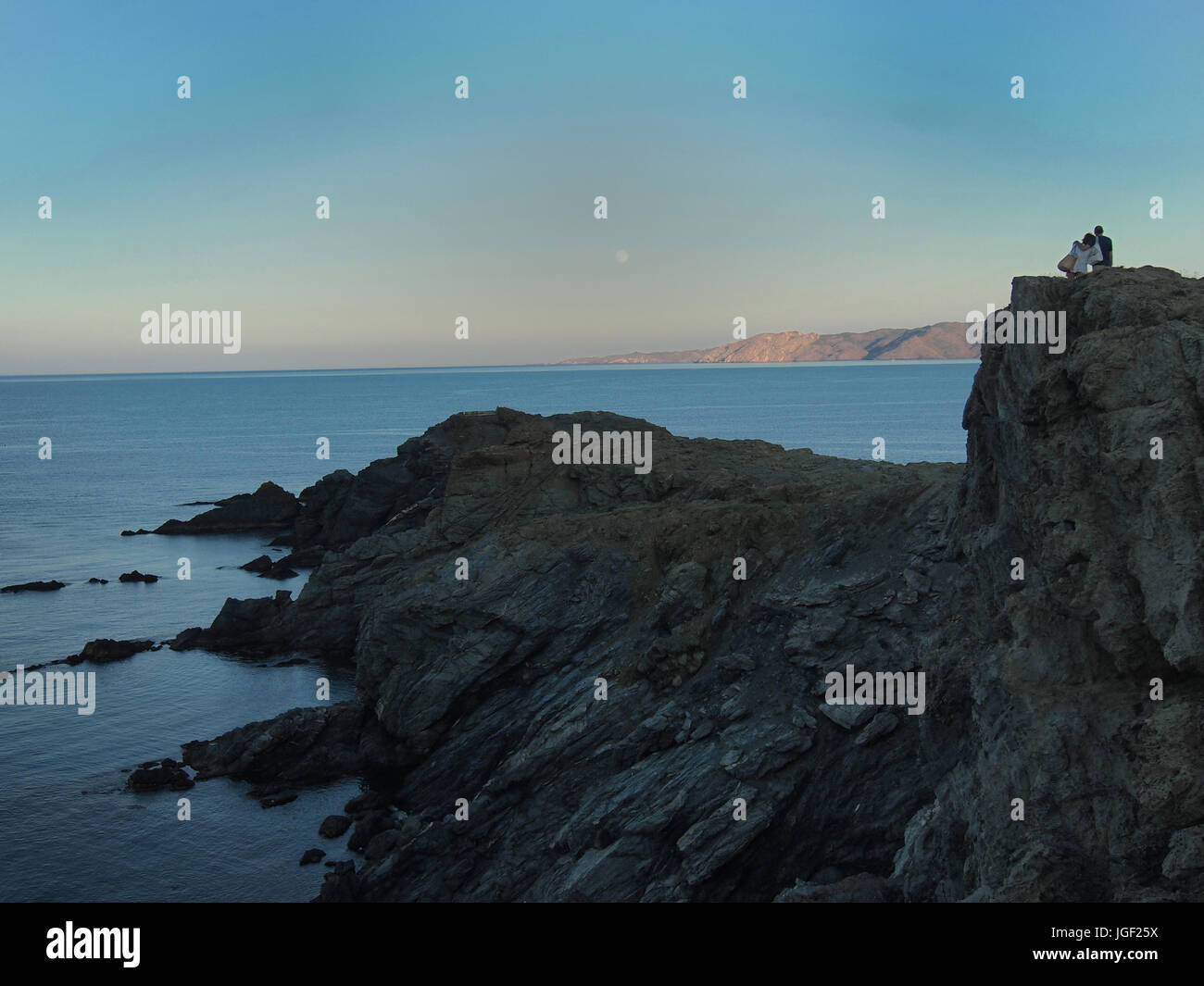 Couple watching the sunset of Cap Ras, Colera, Costa Brava, Girona ...
