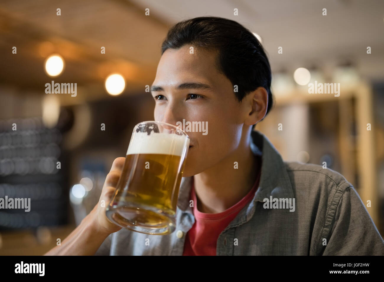 Handsome man having beer in a restaurant Stock Photo - Alamy
