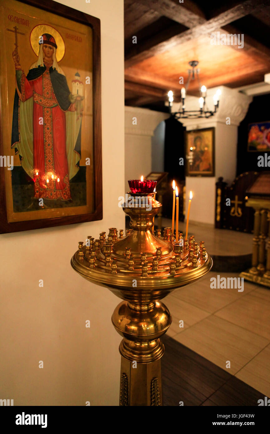 Interior of russian orthodox church. Candles under the ancient icon ...
