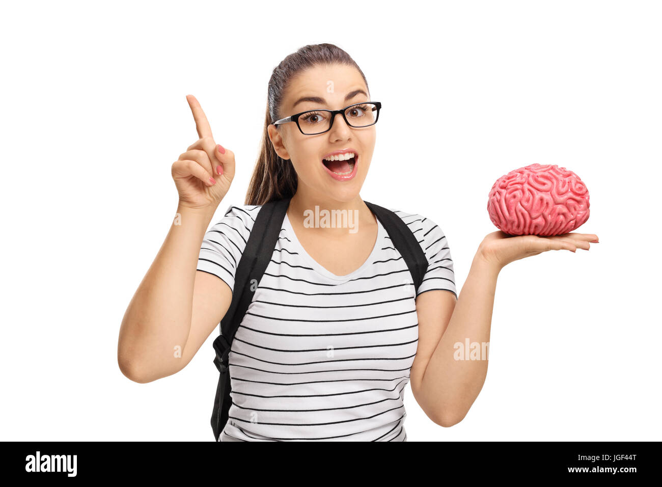 Teenage student holding a brain model and gesturing with her finger ...