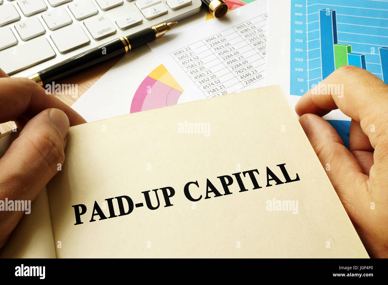 Book with title paid-up capital in an office Stock Photo - Alamy