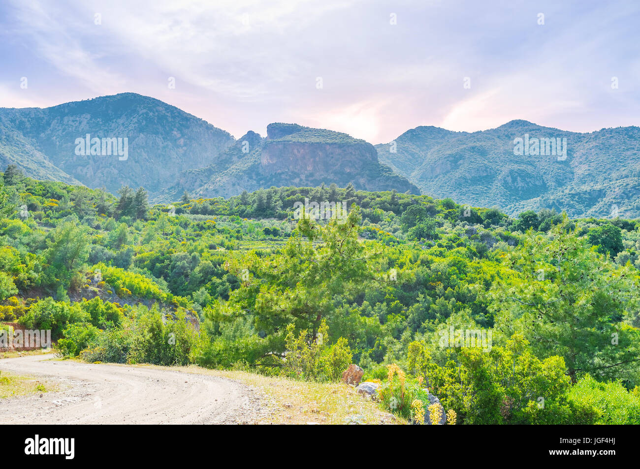 The hilly country road leads to archaeological site Pinara, located on ...