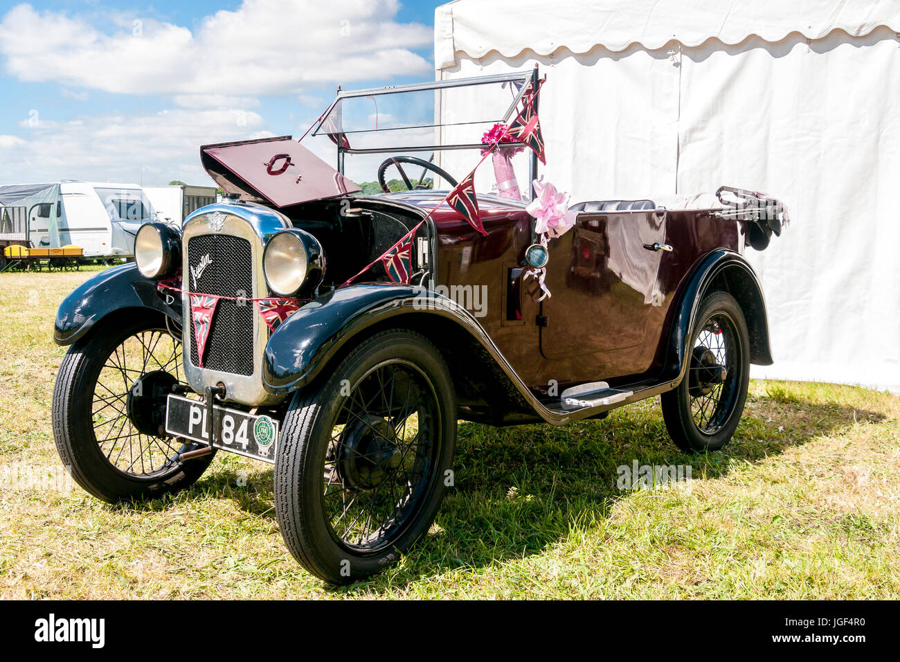 Red and black Austin 7 vintage open top, car with open bonnet at the ...