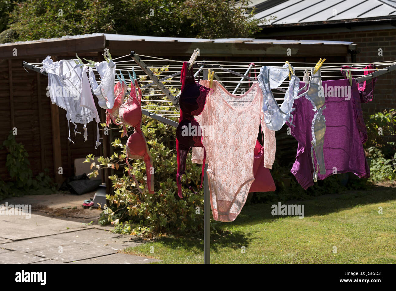 Washing hanging to dry on a rotary clothes line Stock Photo - Alamy