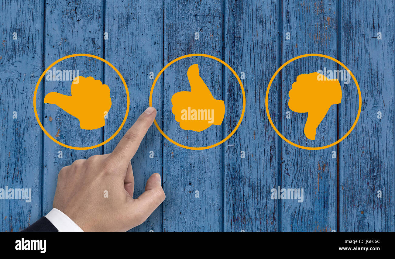 Hand pointing at rating icons with thumb Stock Photo - Alamy