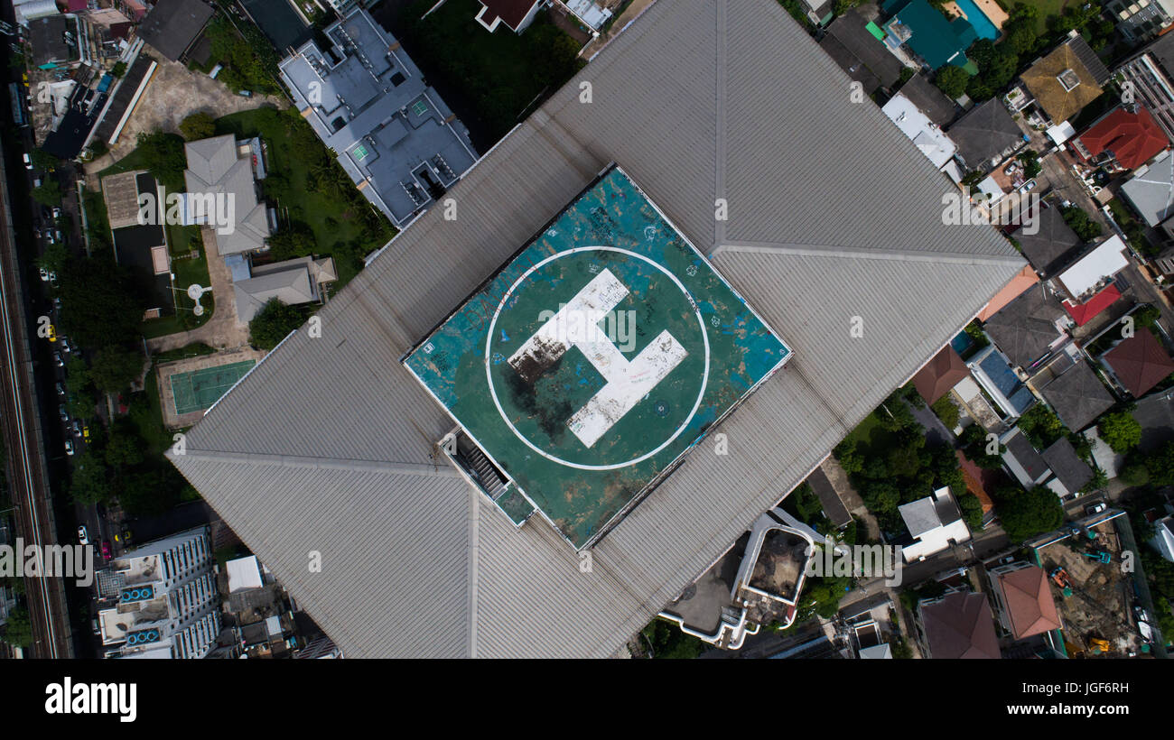Aerial drone top view of helipad isolated on top of the skycraper in ...