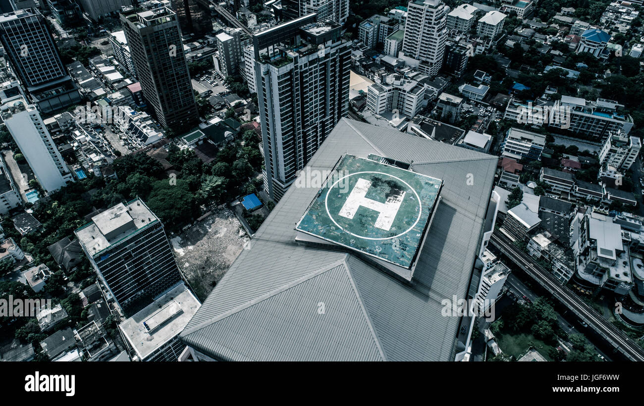 Aerial drone top view of helipad isolated on top of the skycraper in ...