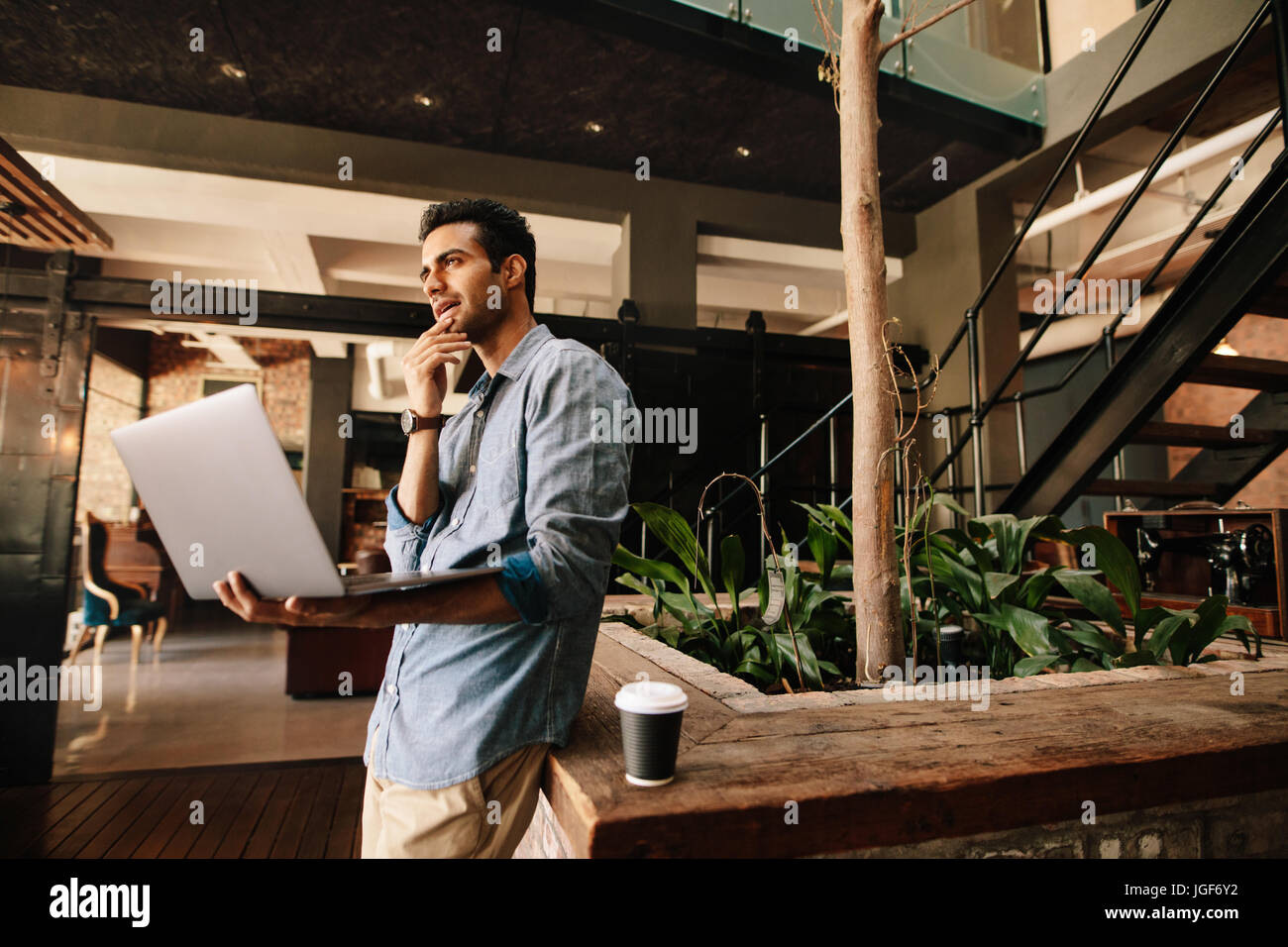 Office using laptop hi-res stock photography and images - Alamy