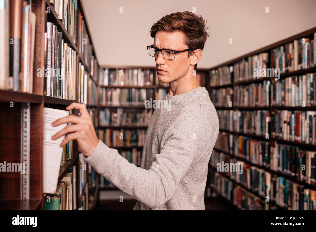 Reaching high shelf hi-res stock photography and images - Alamy