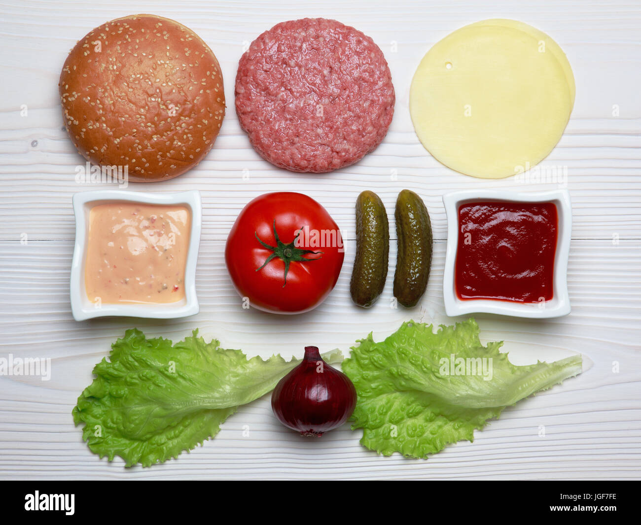 Ingredients for hamburger on white wooden table Stock Photo - Alamy