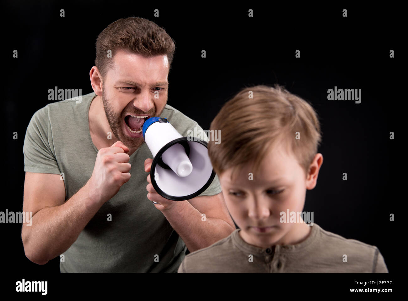 Father with megaphone screaming at scared little son, family problems ...