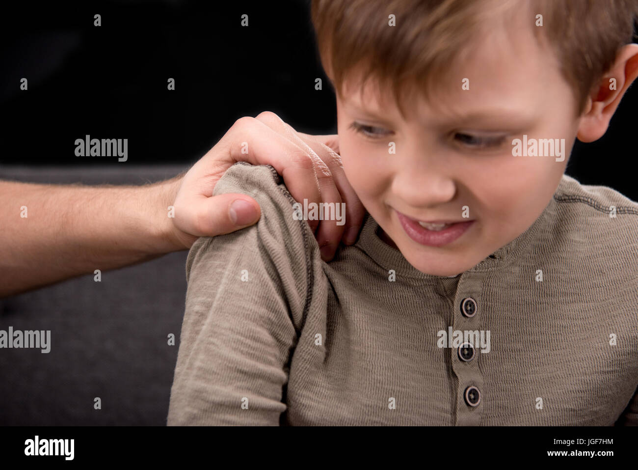 Close-up partial view of father threatening to scared little boy ...
