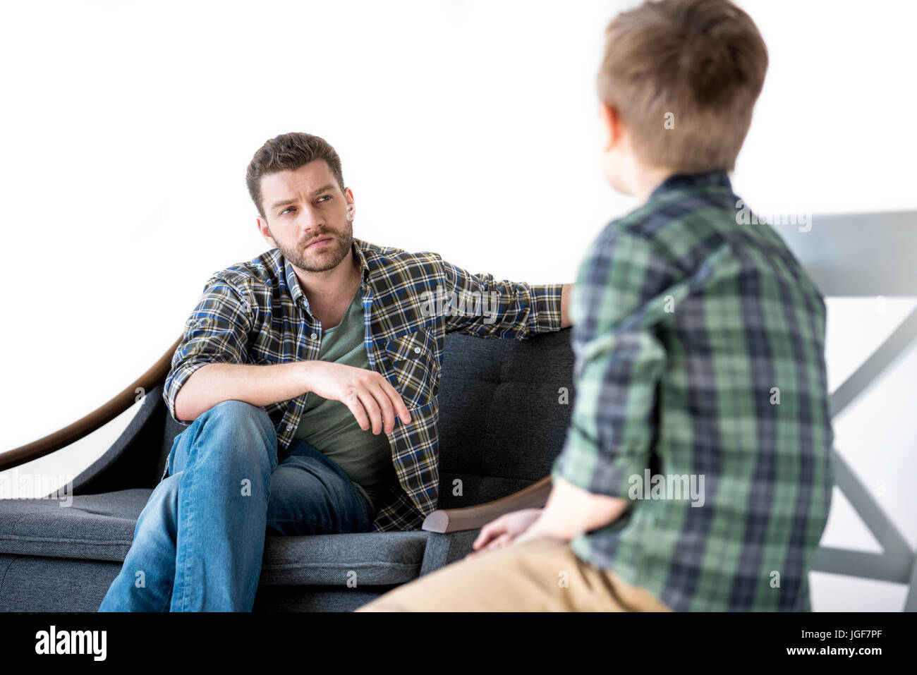 Serious father looking at little son, family problems concept Stock ...