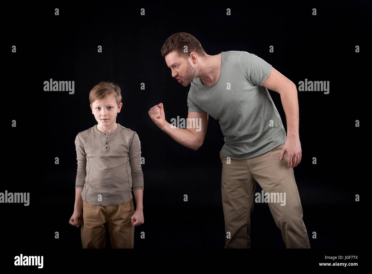 Angry father threatening and gesturing to scared little son, family ...