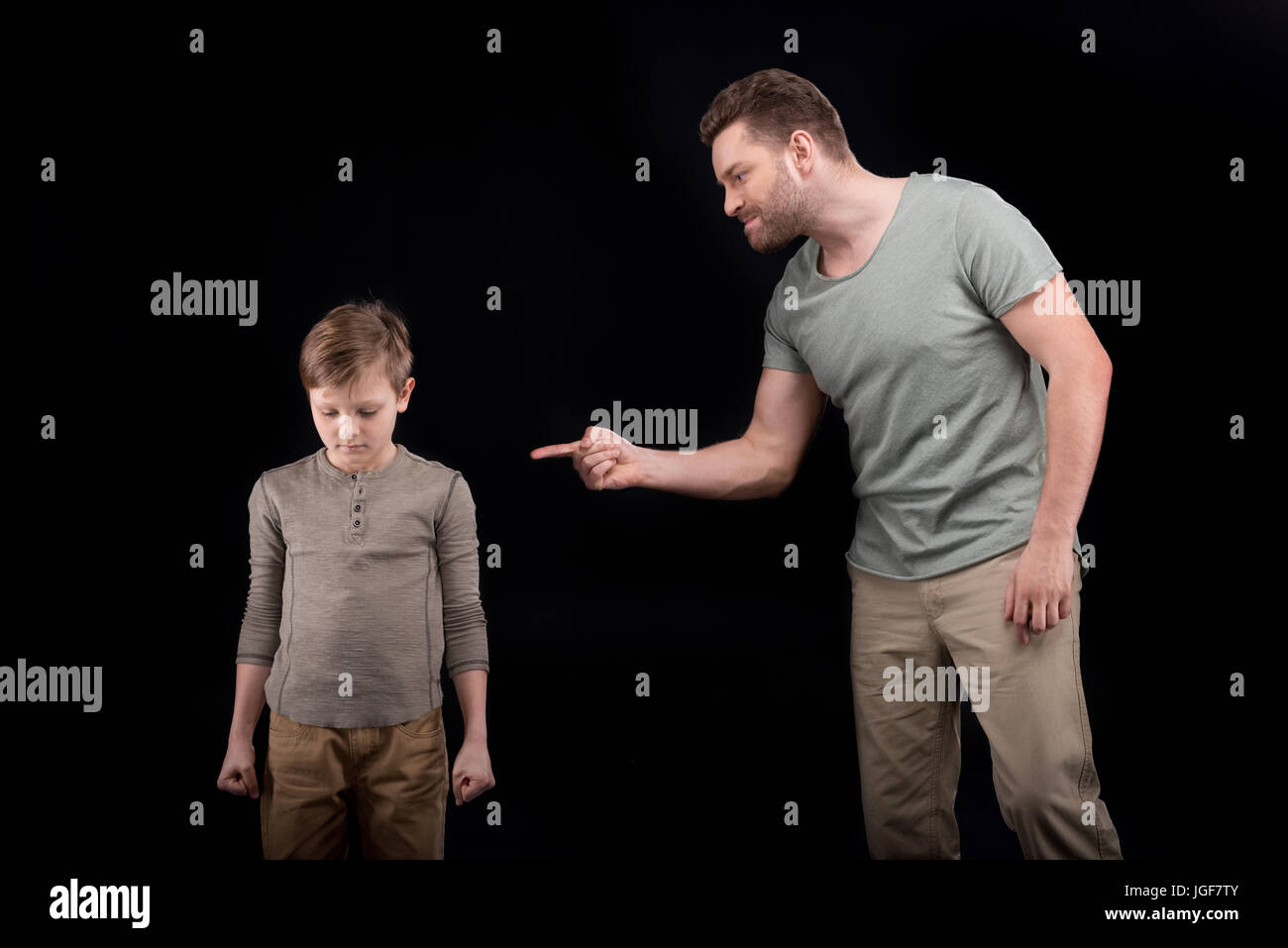 Angry father threatening and gesturing to scared little son, family ...