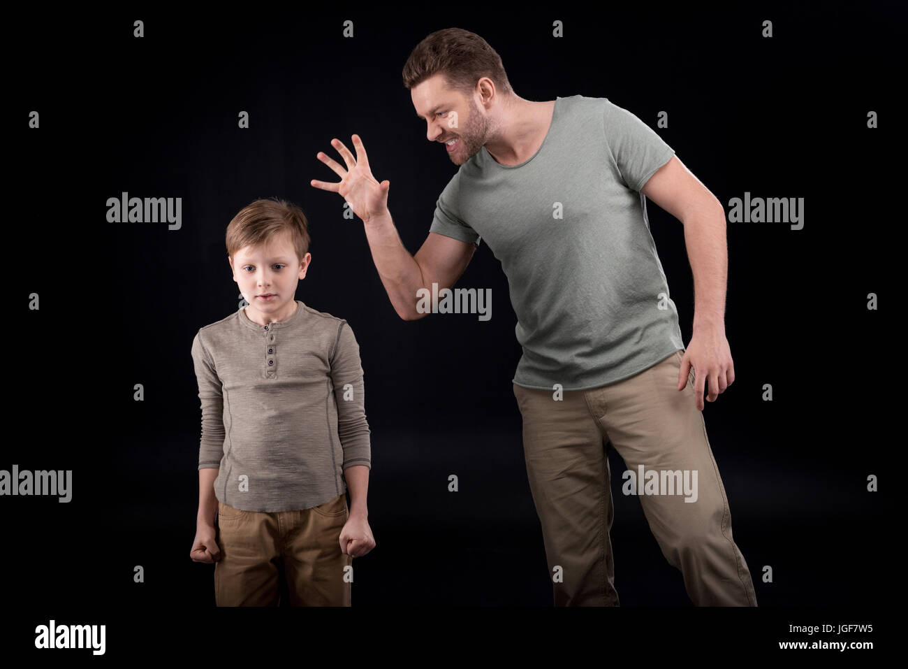 Angry father threatening and gesturing to scared little son, family ...