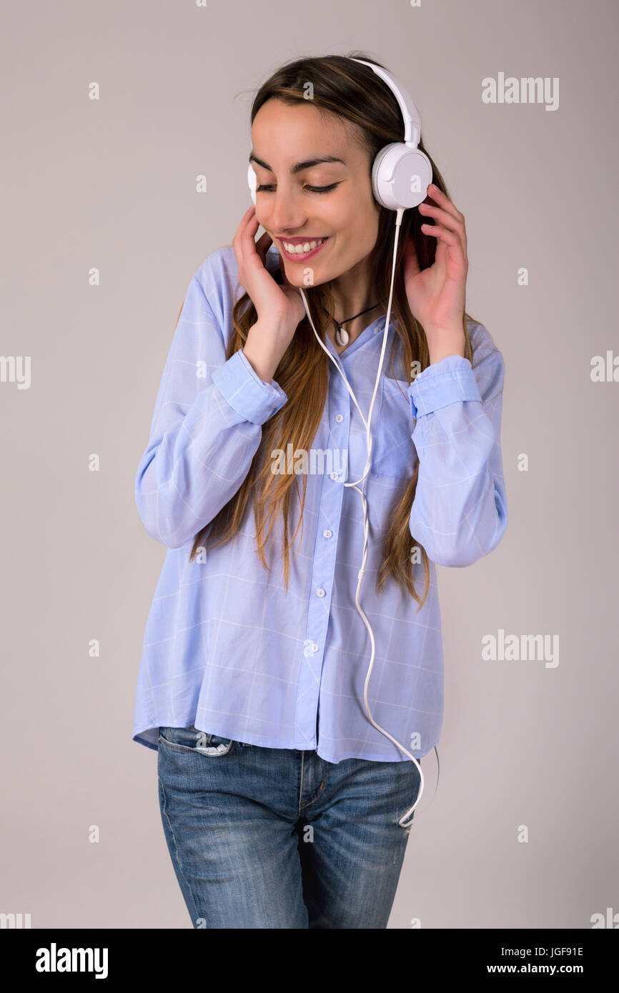 Beautiful young woman listen music with headphones Stock Photo - Alamy